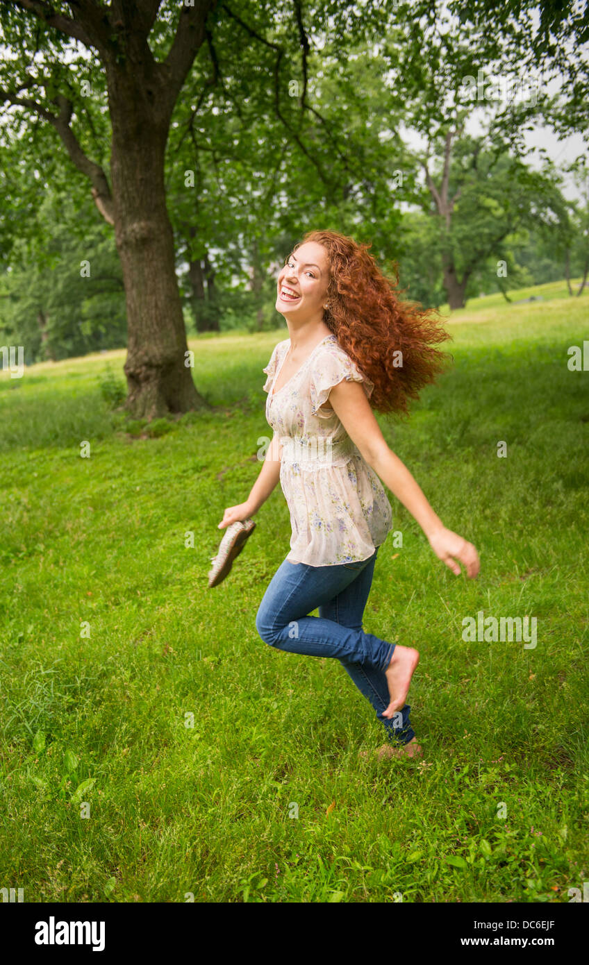 Young woman running in park Stock Photo - Alamy