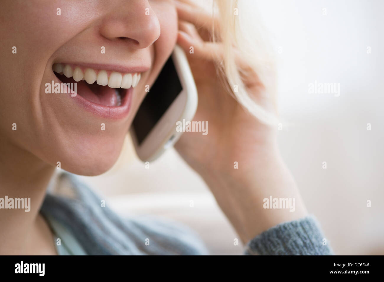 Woman blonde holding smartphone smiling hi-res stock photography and ...