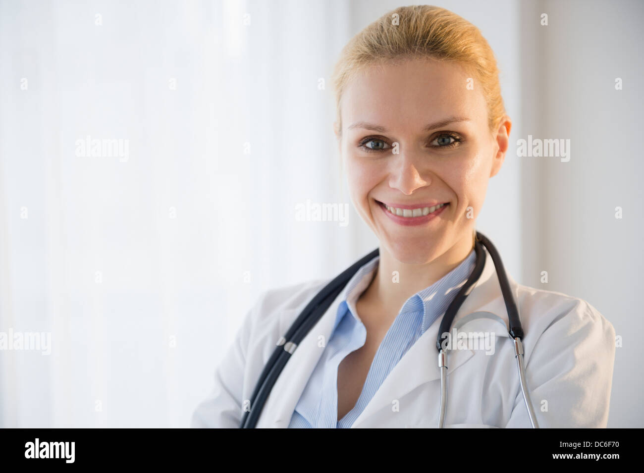 Portrait happy blonde female doctor hi-res stock photography and images - Alamy