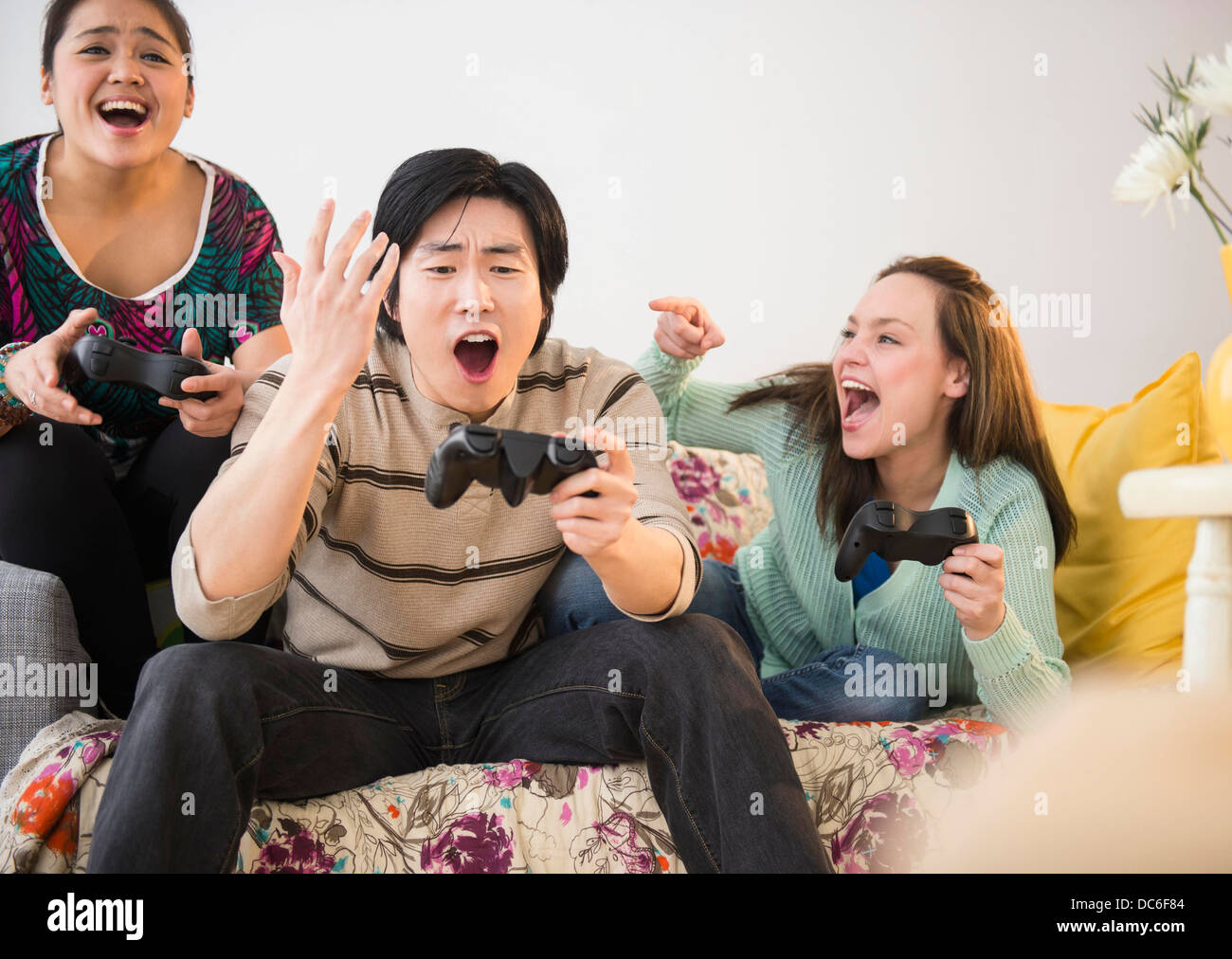 Young women and man playing video game Stock Photo - Alamy