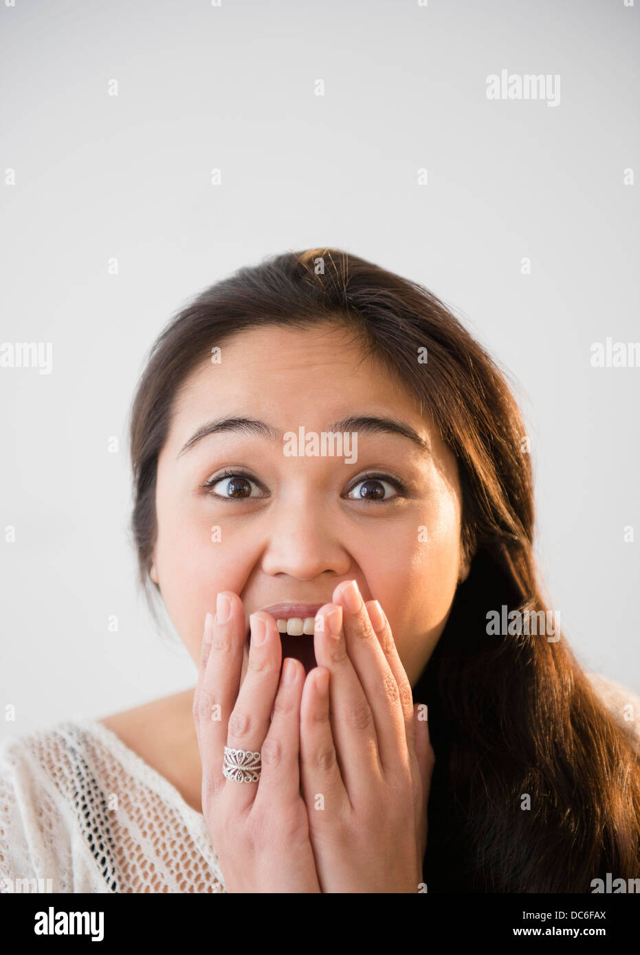 Young woman covering mouth laughing hi-res stock photography and images ...