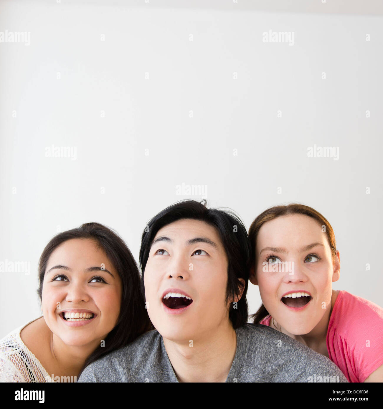 Friends looking up happily Stock Photo - Alamy