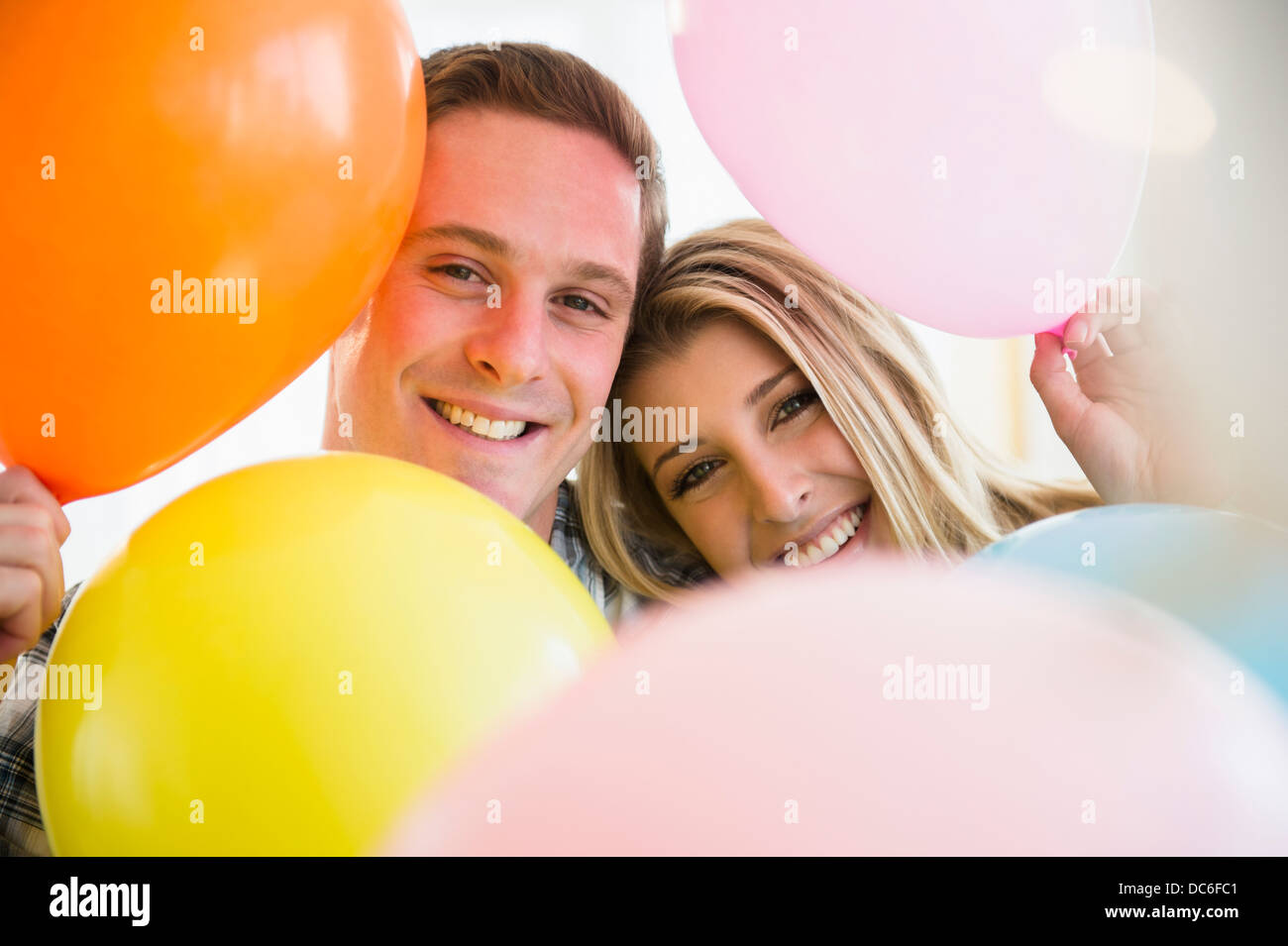 Couple with colorful balloons Stock Photo - Alamy