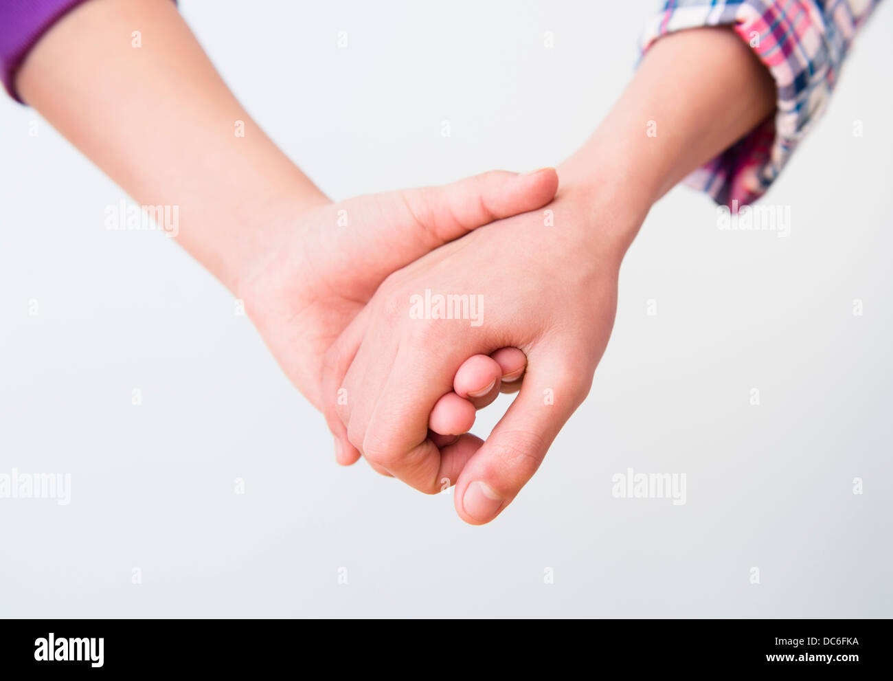 Close-up view of friends holding hands Stock Photo - Alamy