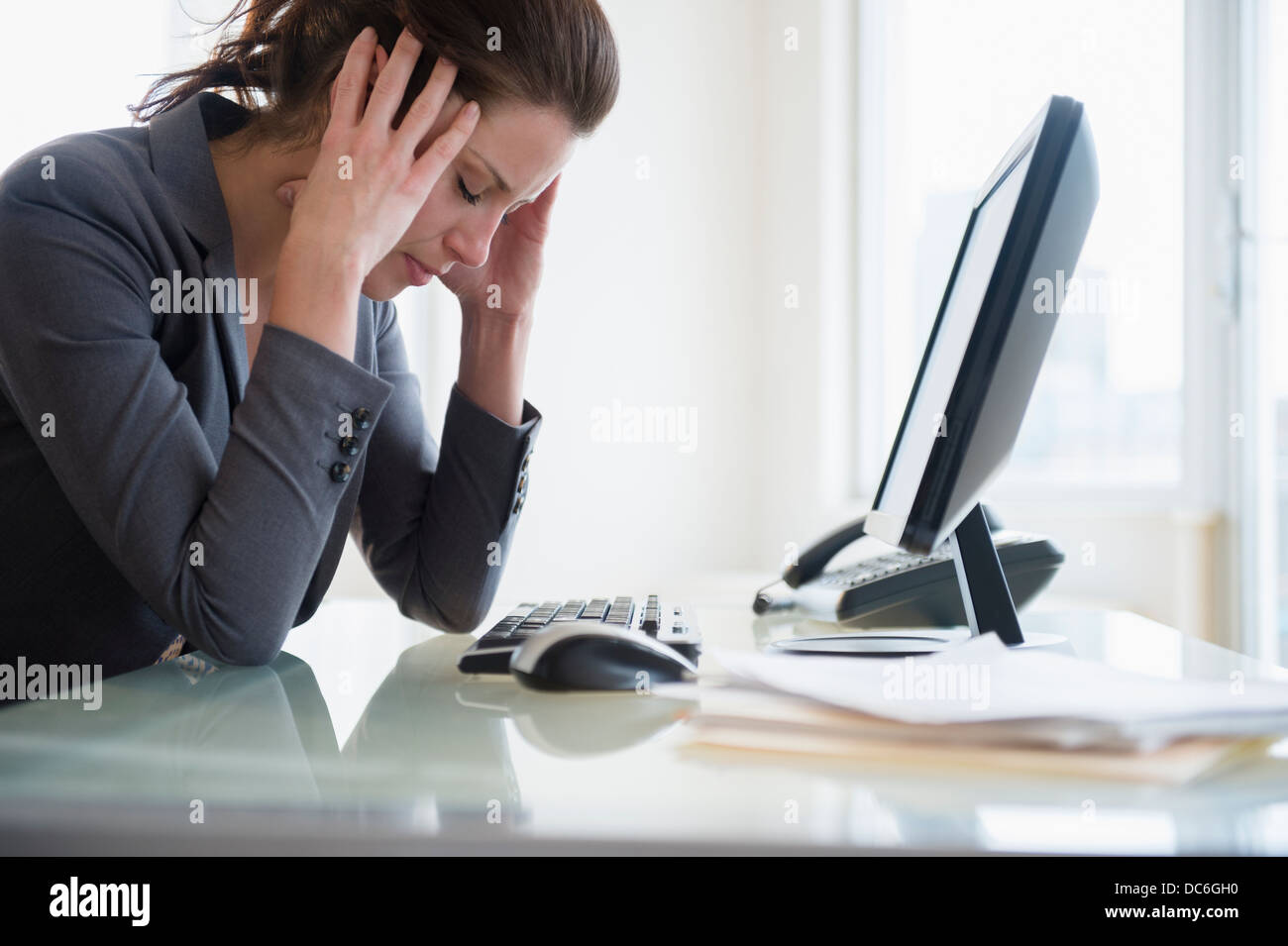 Portrait of overtired woman in office Stock Photo - Alamy