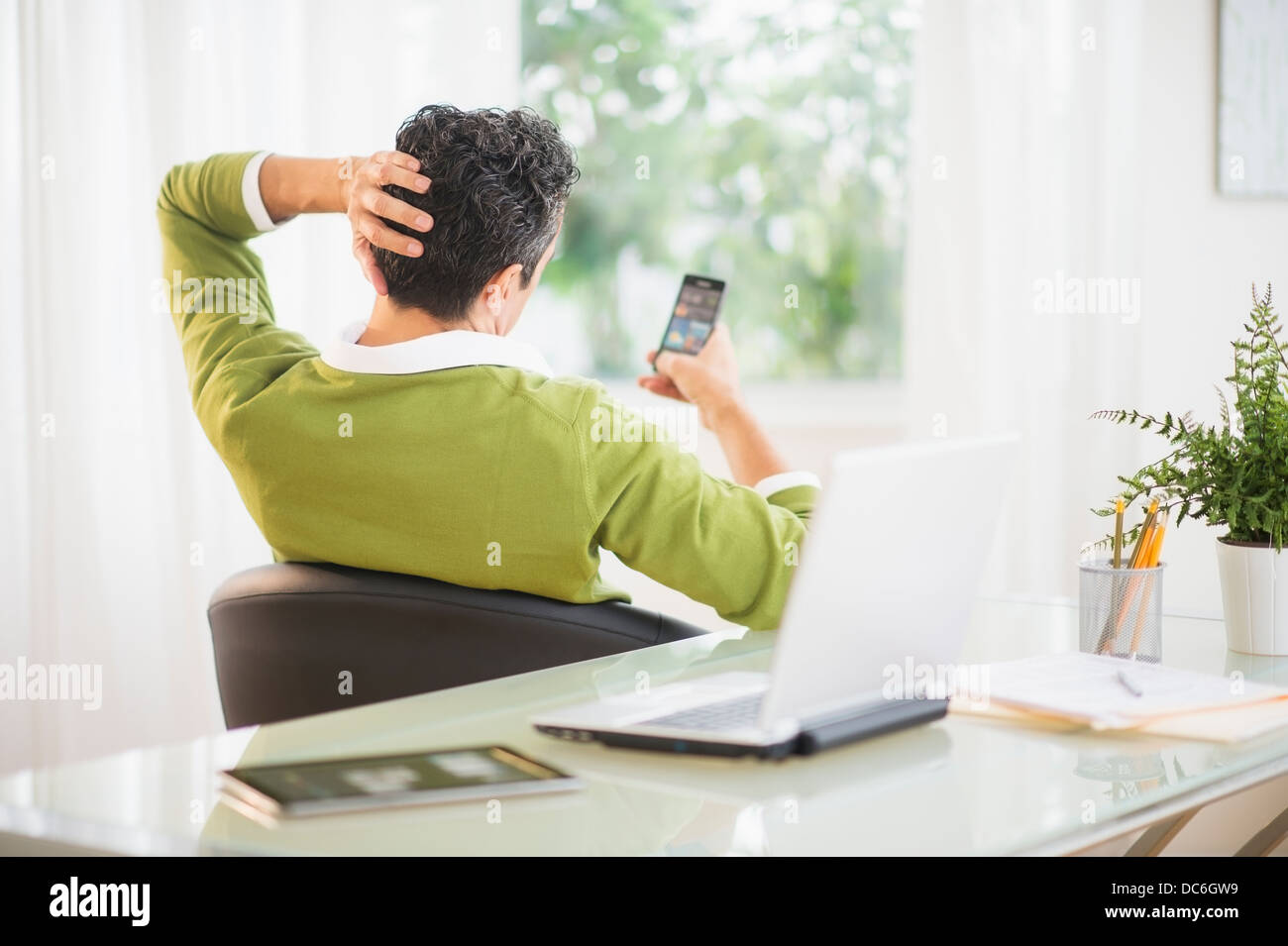 Rear view of man using mobile phone Stock Photo - Alamy