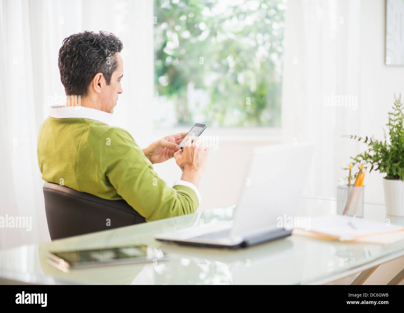 Side view of man using mobile phone Stock Photo - Alamy