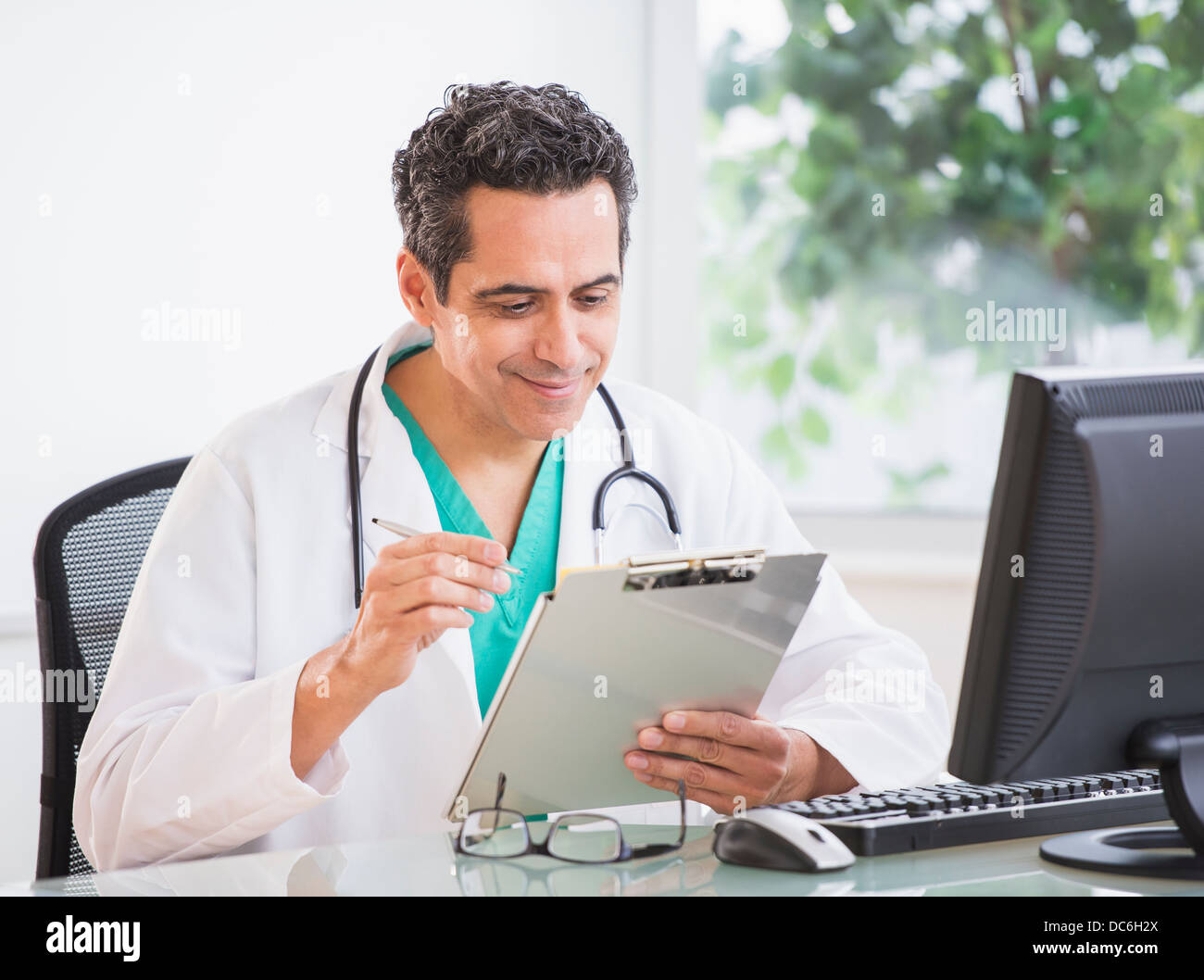 Portrait of doctor working in office Stock Photo - Alamy