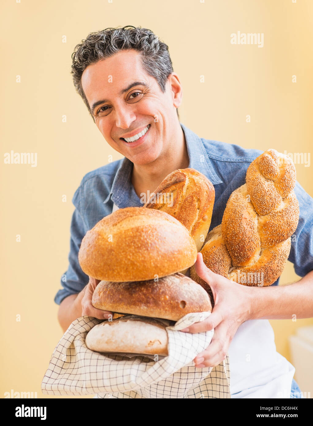 Studio shot of baker holding bread Stock Photo - Alamy