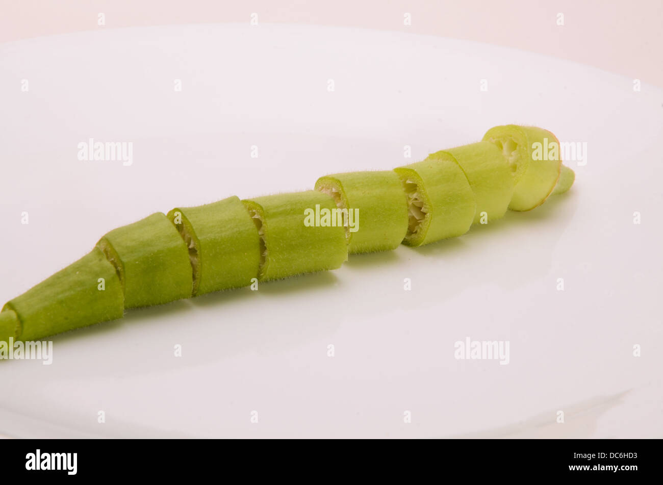 Diced okra pod on a white background Stock Photo - Alamy