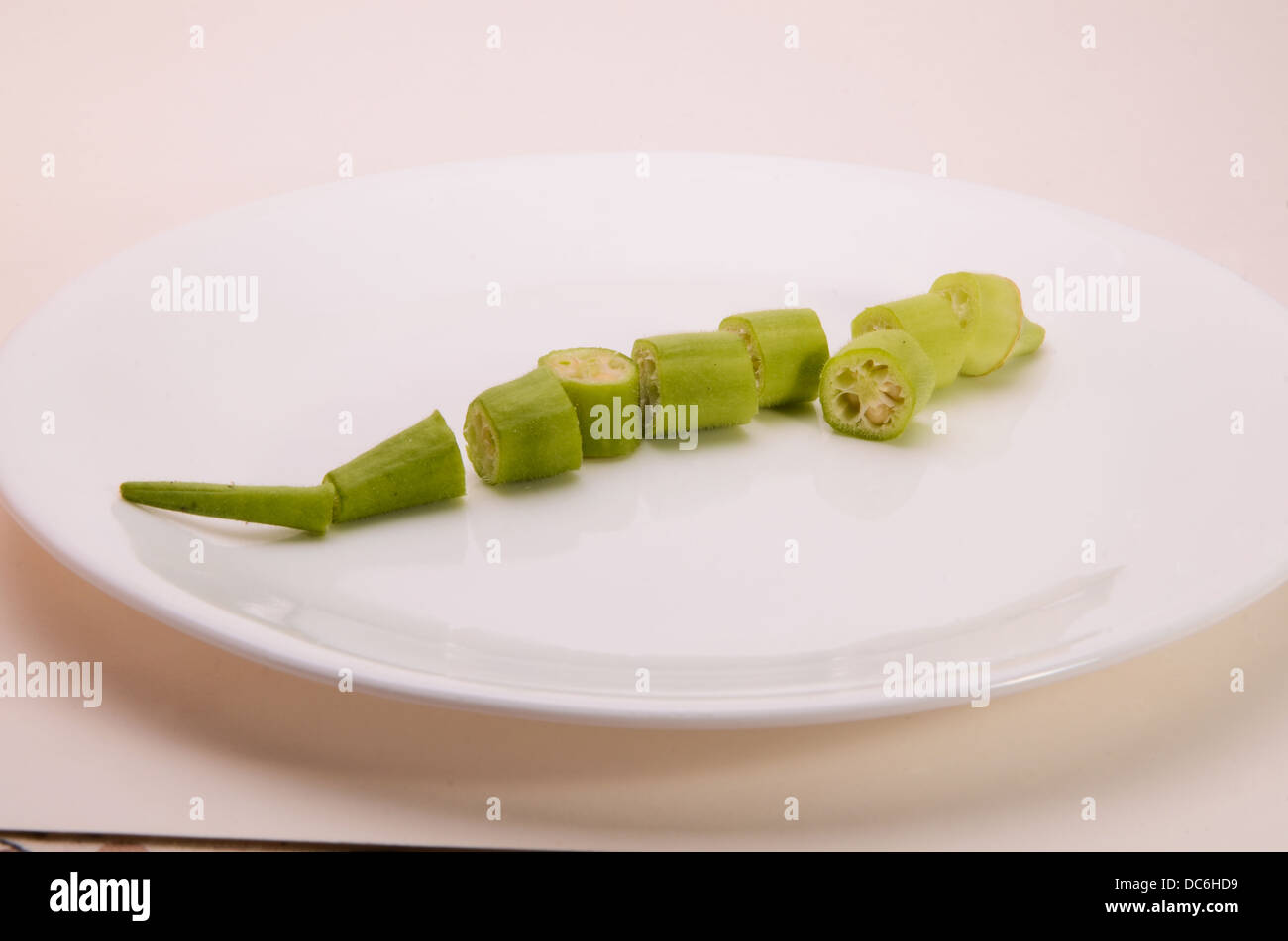 Diced okra pod on a white saucer Stock Photo - Alamy