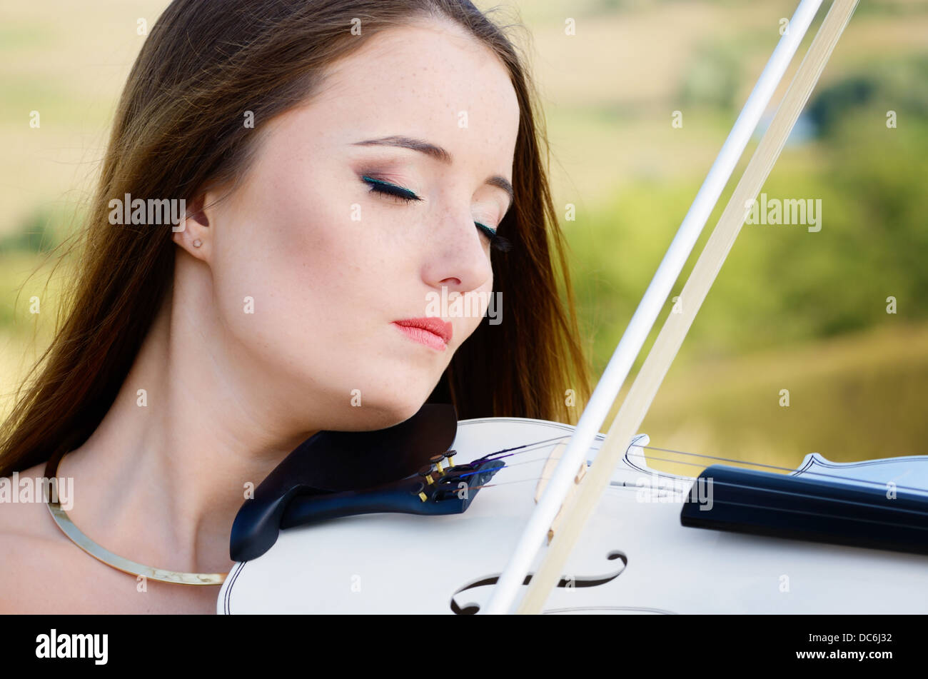Young beautiful violin player with white fiddle Stock Photo - Alamy