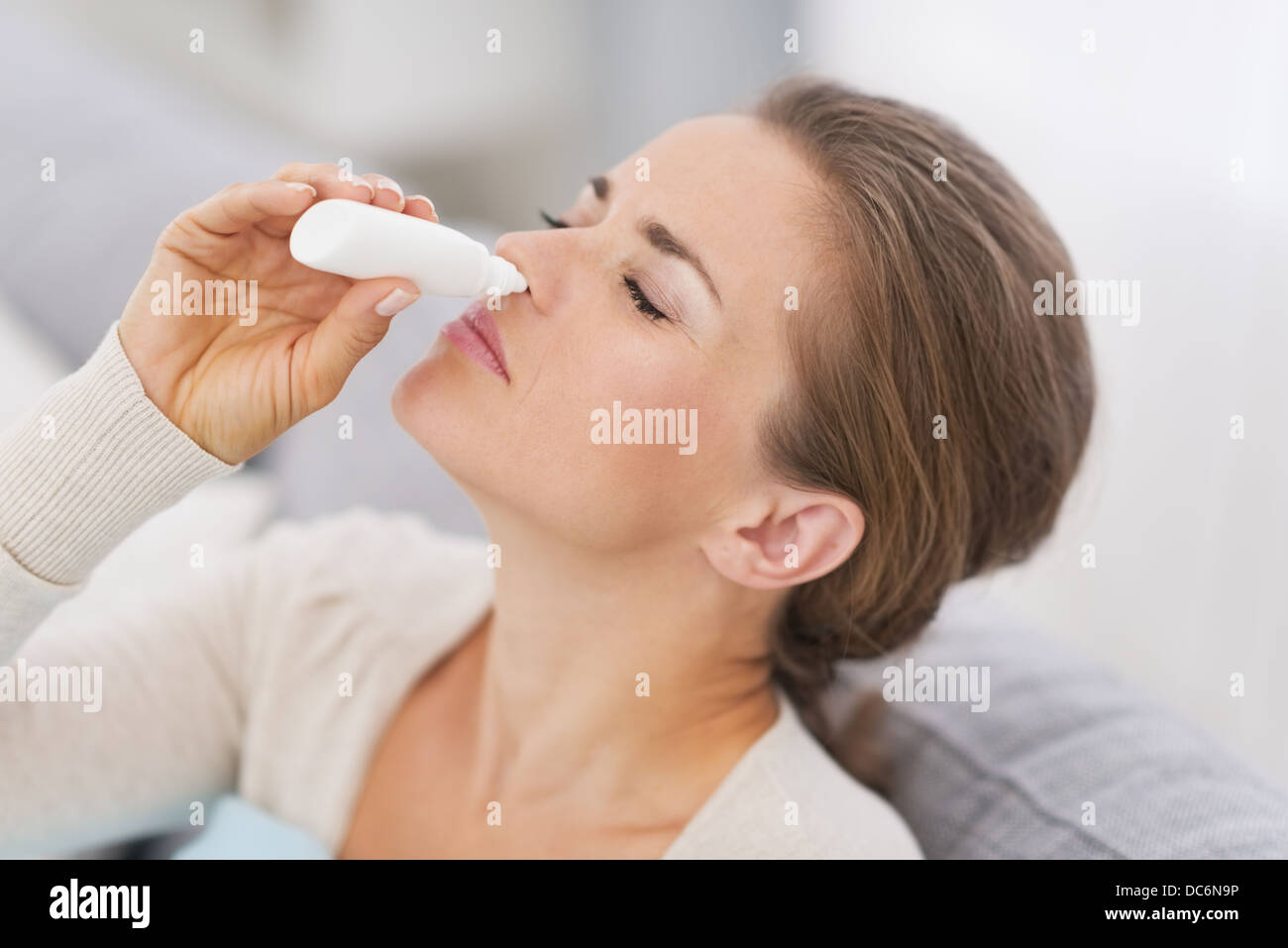 Woman using nasal drops Stock Photo - Alamy