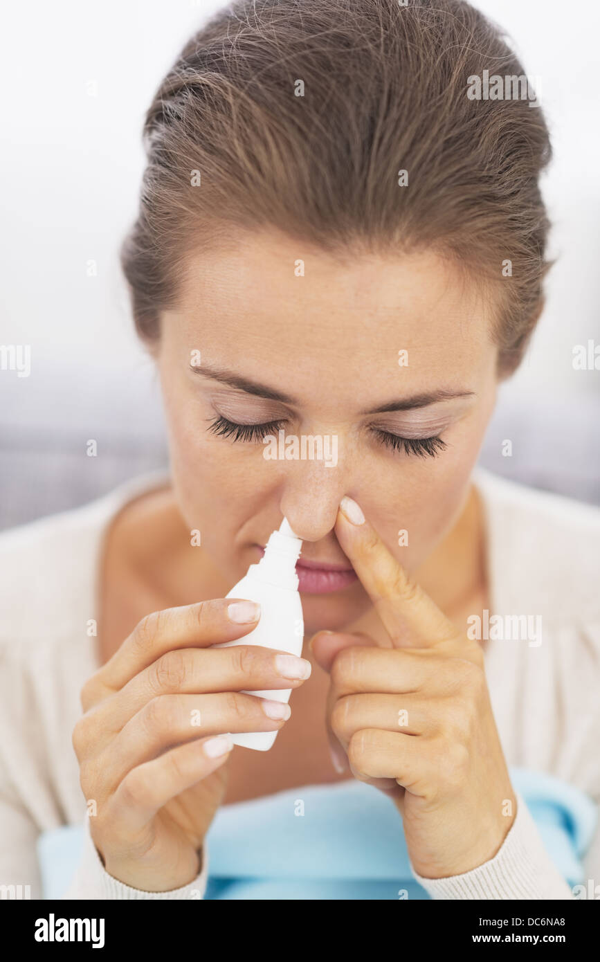 Woman using nasal drops Stock Photo - Alamy
