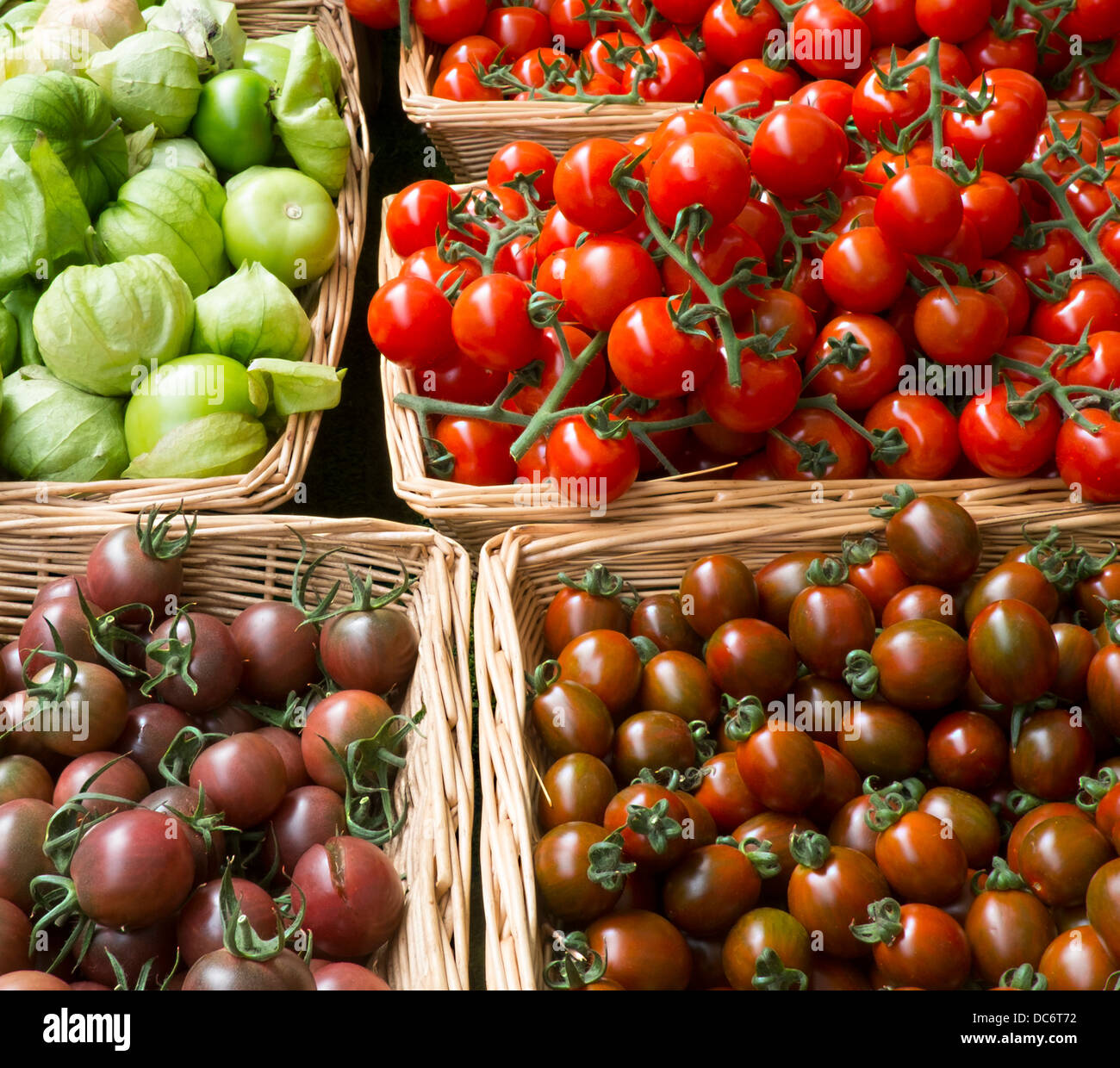 Different coloured tomatoes on sale at a market stall In London, UK ...