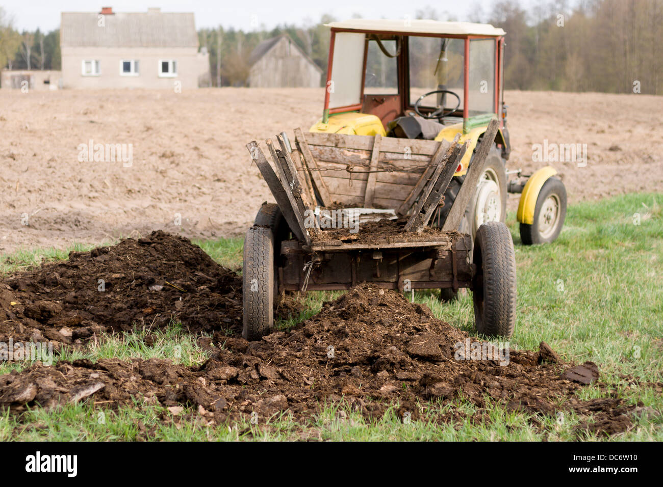 Animal manure being delivered by rustic tractor/trailer Stock Photo - Alamy