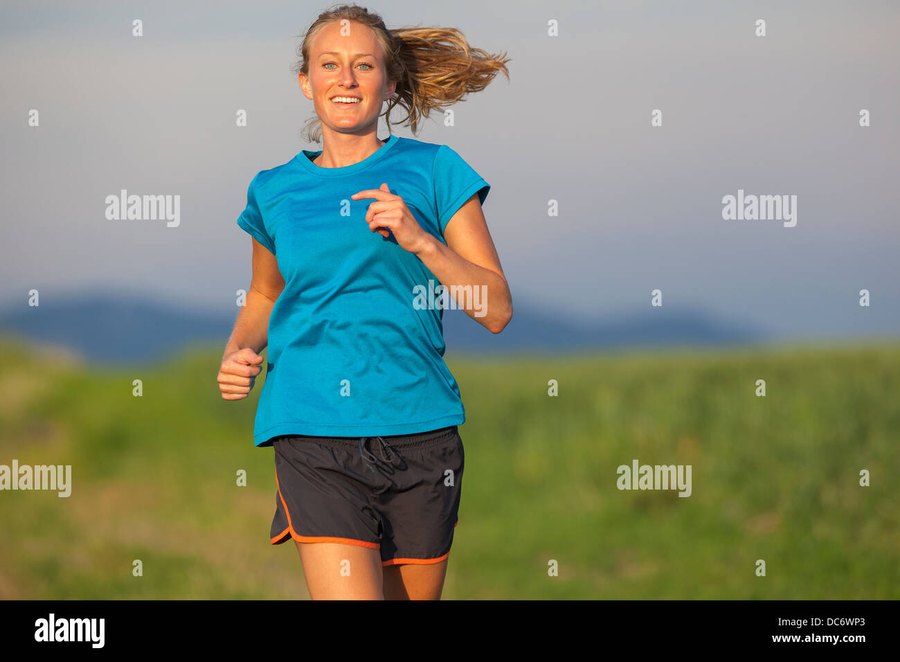 USA, Montana, Kalispell, Front view of young woman jogging Stock Photo ...