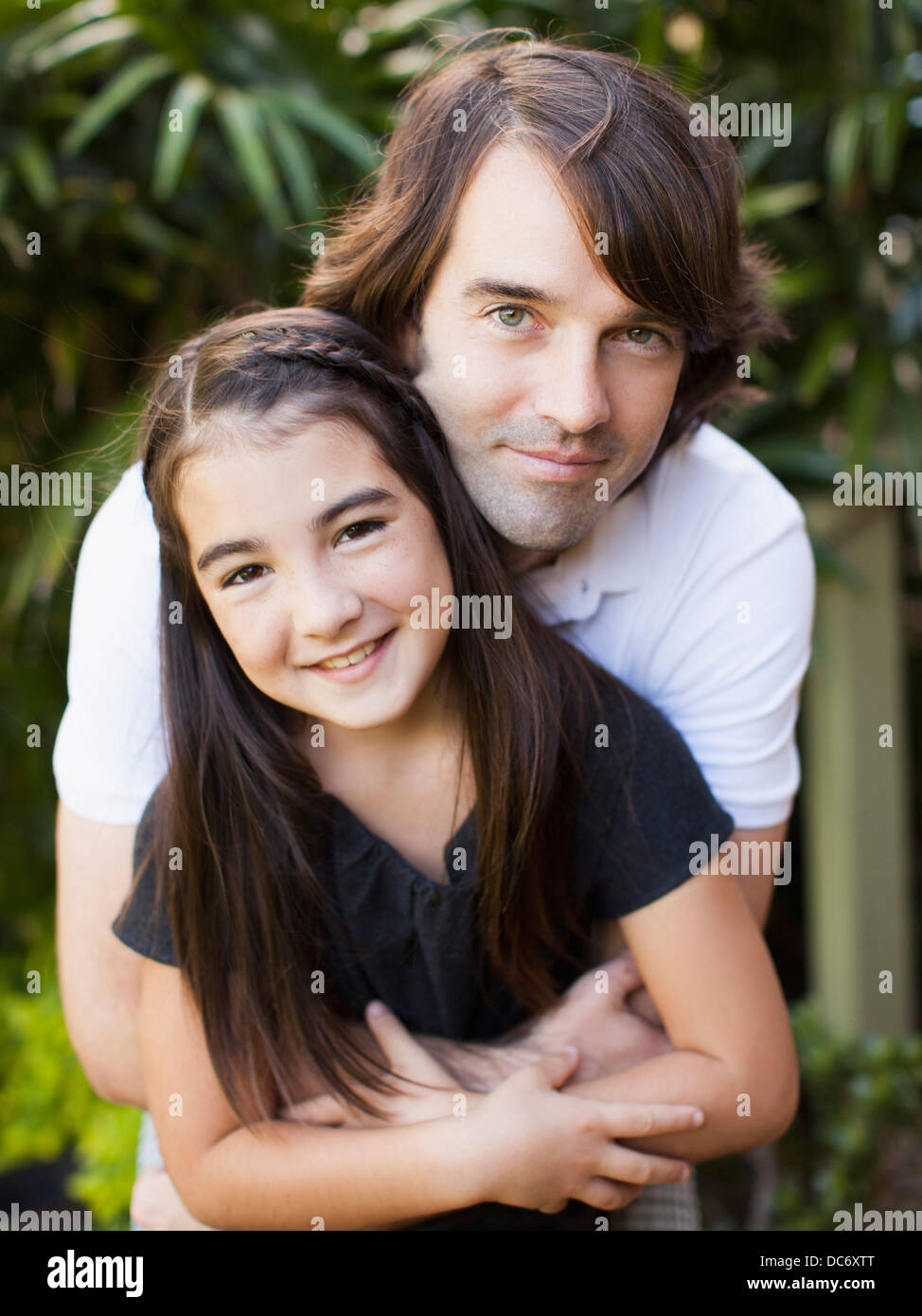 Portrait of father hugging daughter (8-9 Stock Photo - Alamy