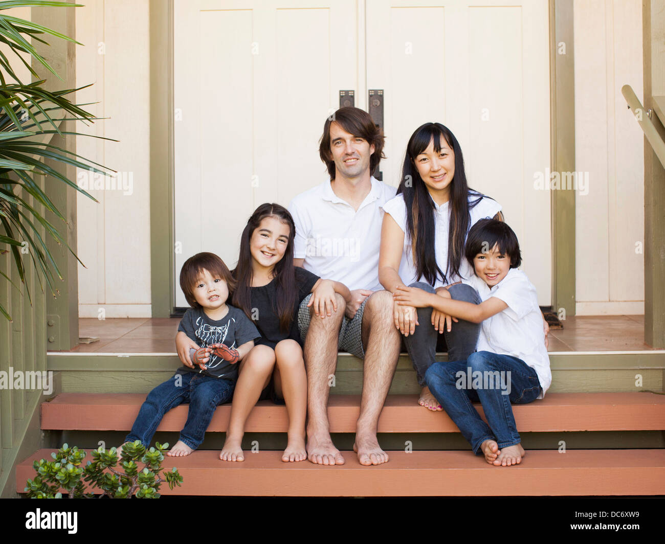 Portrait of family with three kids (2-3, 8-9 Stock Photo - Alamy