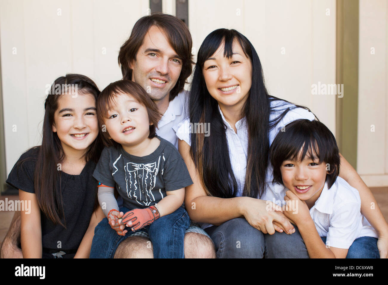 Portrait of family with three kids (2-3, 8-9 Stock Photo - Alamy