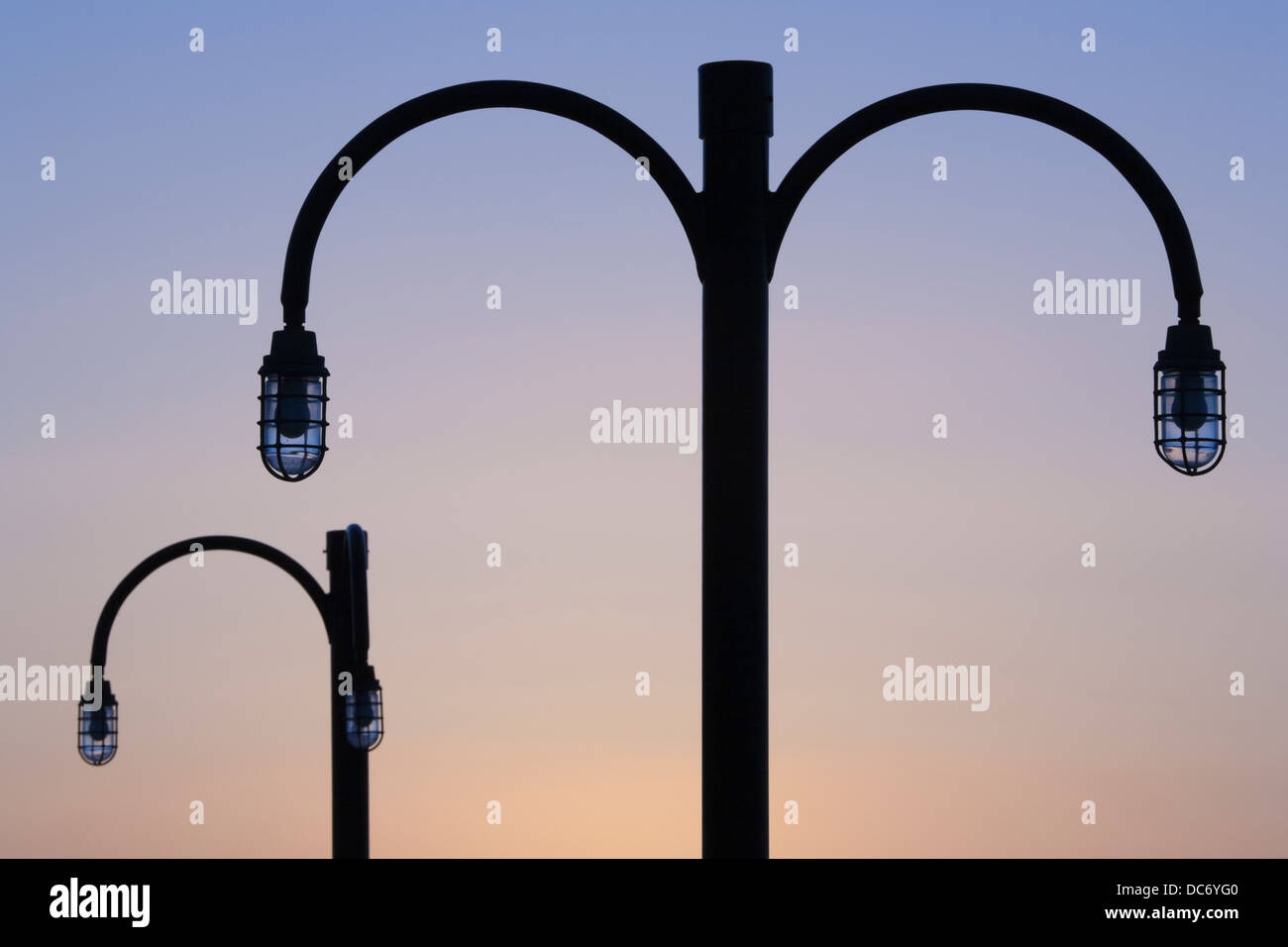 Silhouetted view of boardwalk lamps at daybreak Stock Photo - Alamy