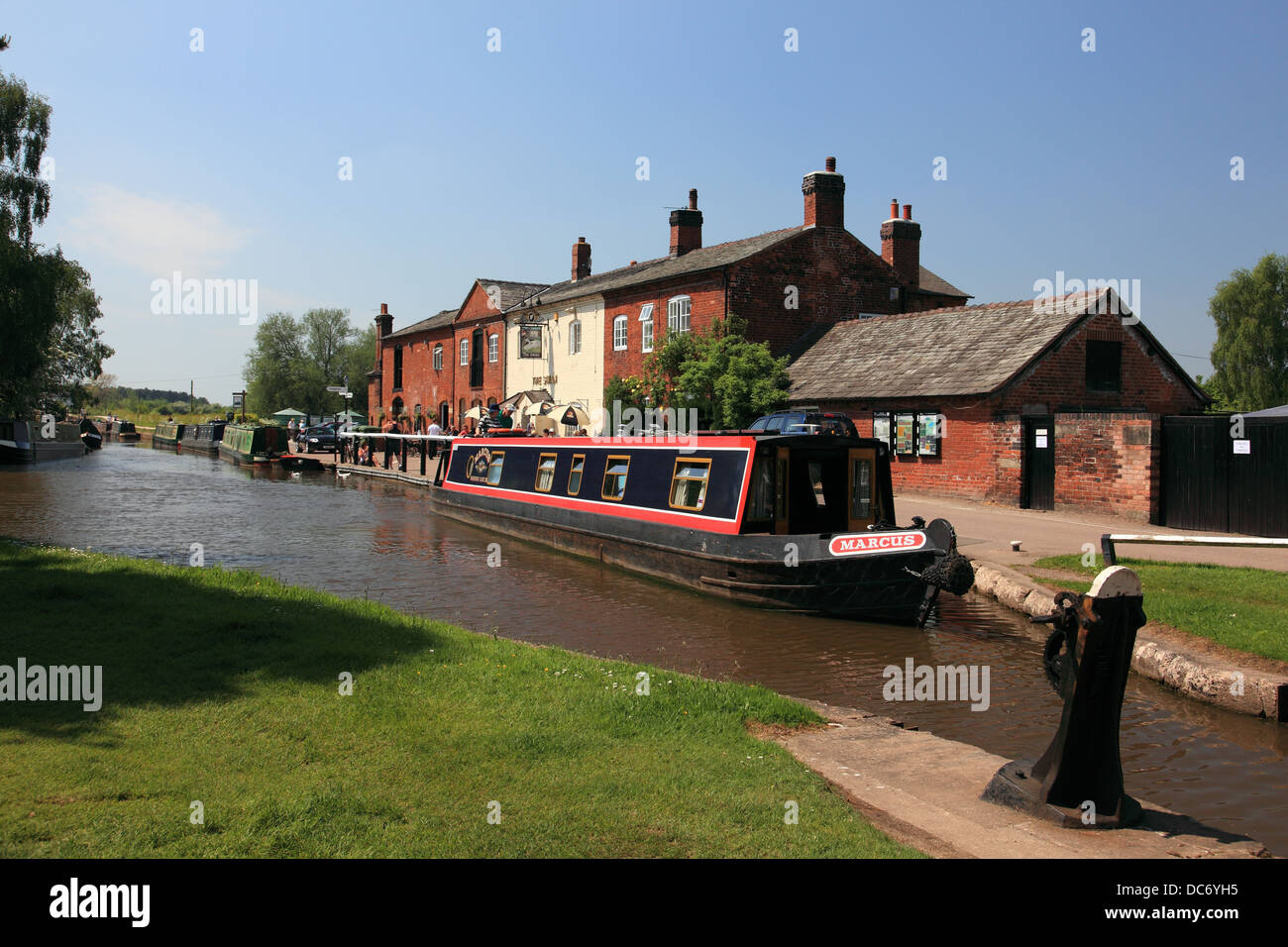 A narrowboat by the pub The Swan at Fradley Junction in Staffordshire ...