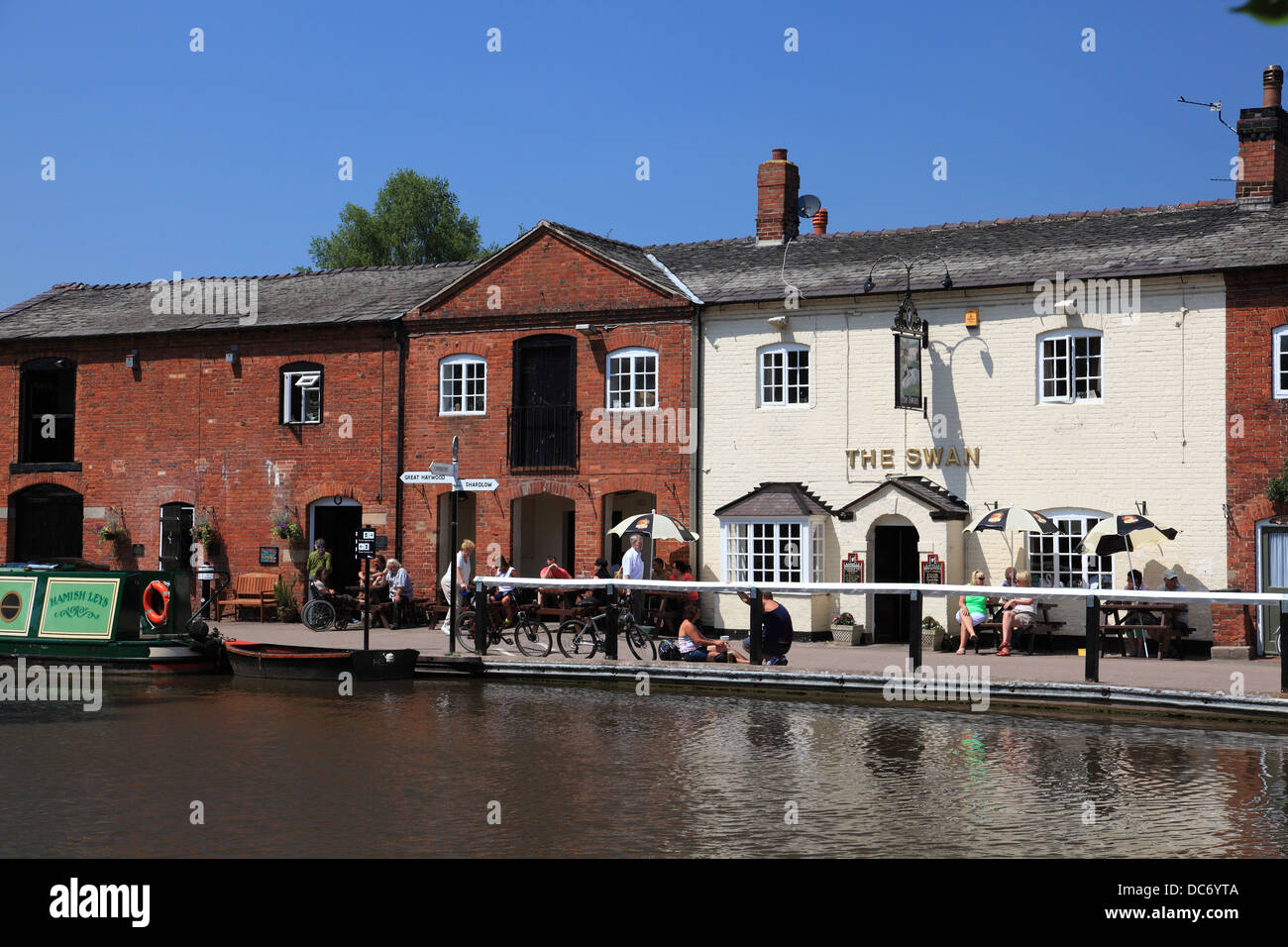A narrowboat by the pub The Swan at Fradley Junction in Staffordshire ...