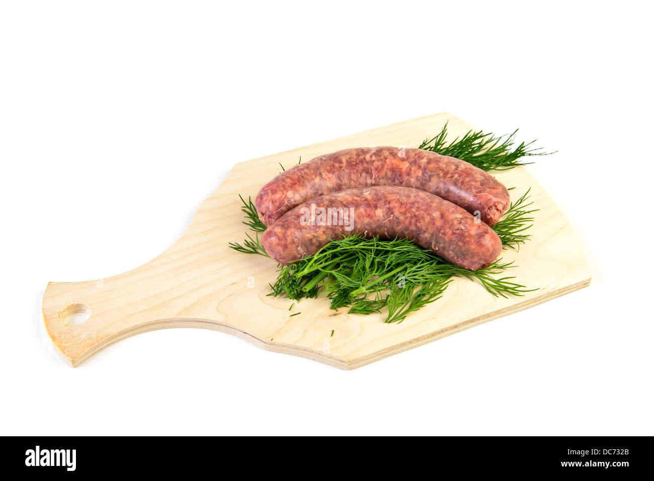 Raw sausages ready to grill at kitchen board Stock Photo - Alamy