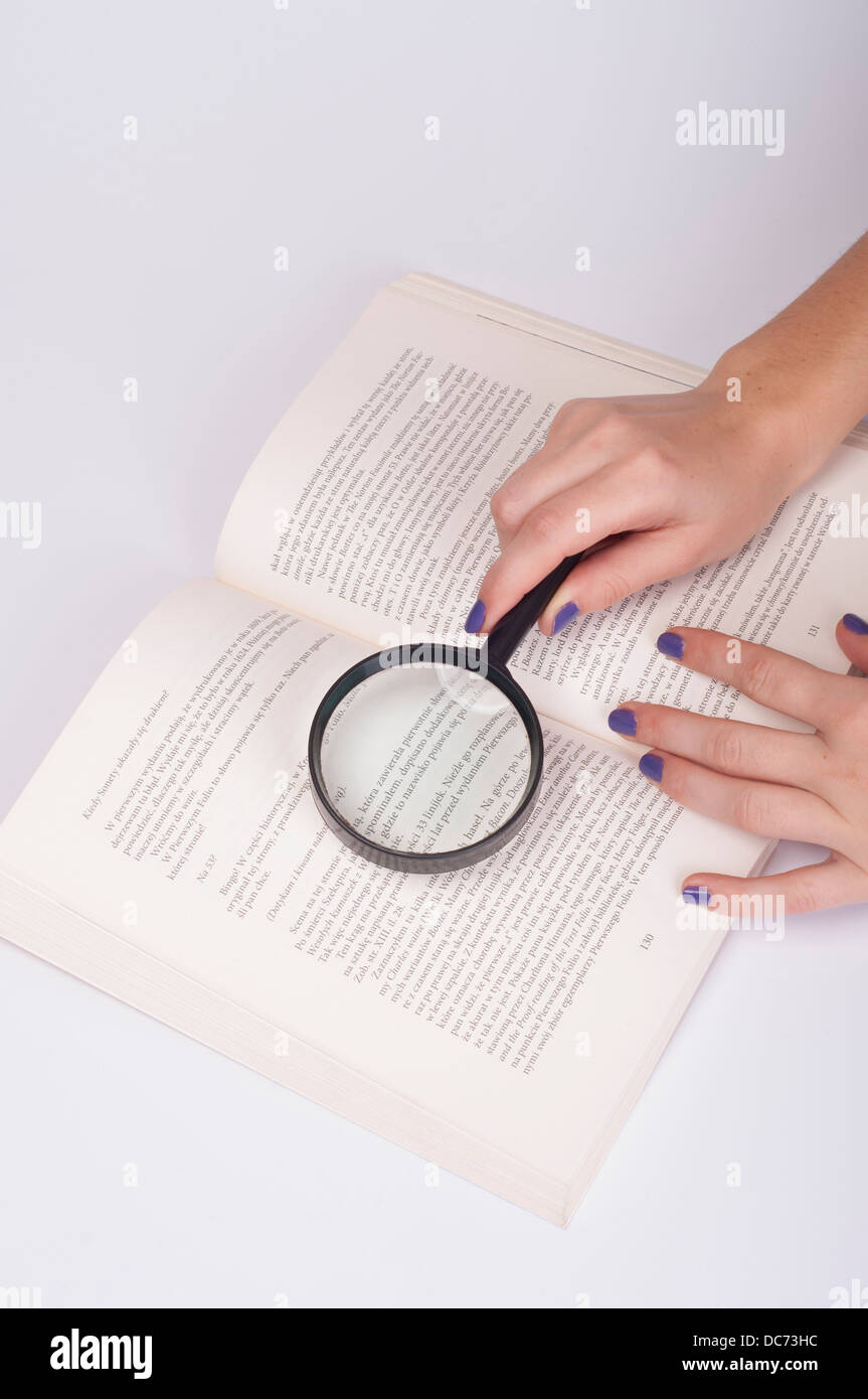an image of magnifying glass over opened book Stock Photo - Alamy