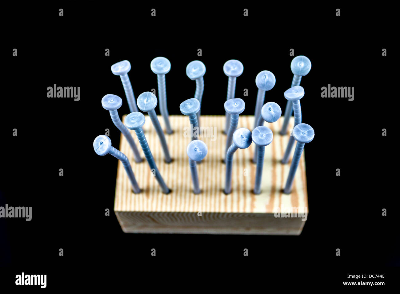 Bunch on nails on wood block hi-res stock photography and images - Alamy