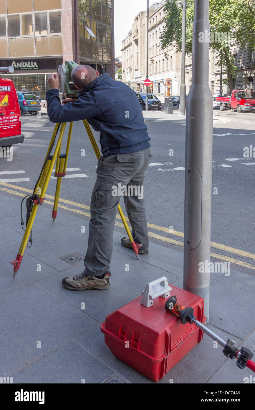 Engineering Land Surveyor using a theodolite to sight a target on a ...