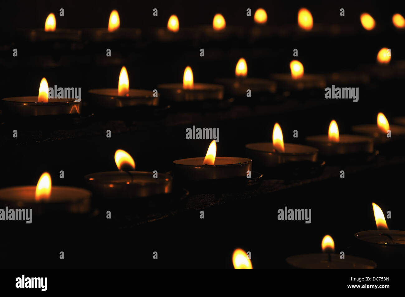 Firing candles in catholic church Stock Photo - Alamy