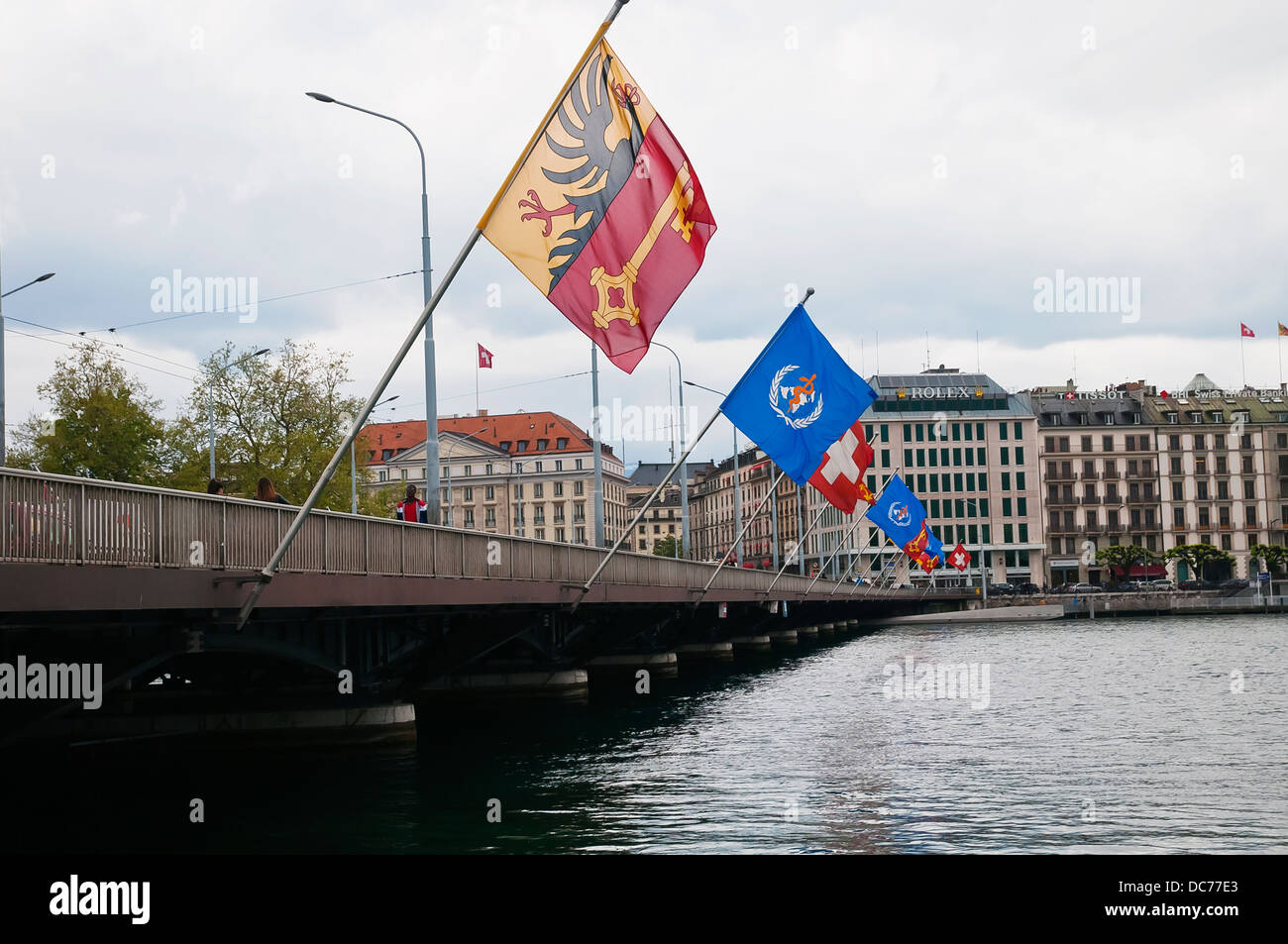 The bridge over lake Geneva with flags of Geneva ,the province and the ...