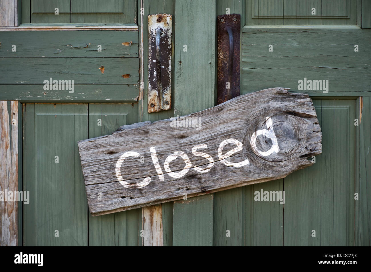 Old closed sign on green doors Stock Photo - Alamy