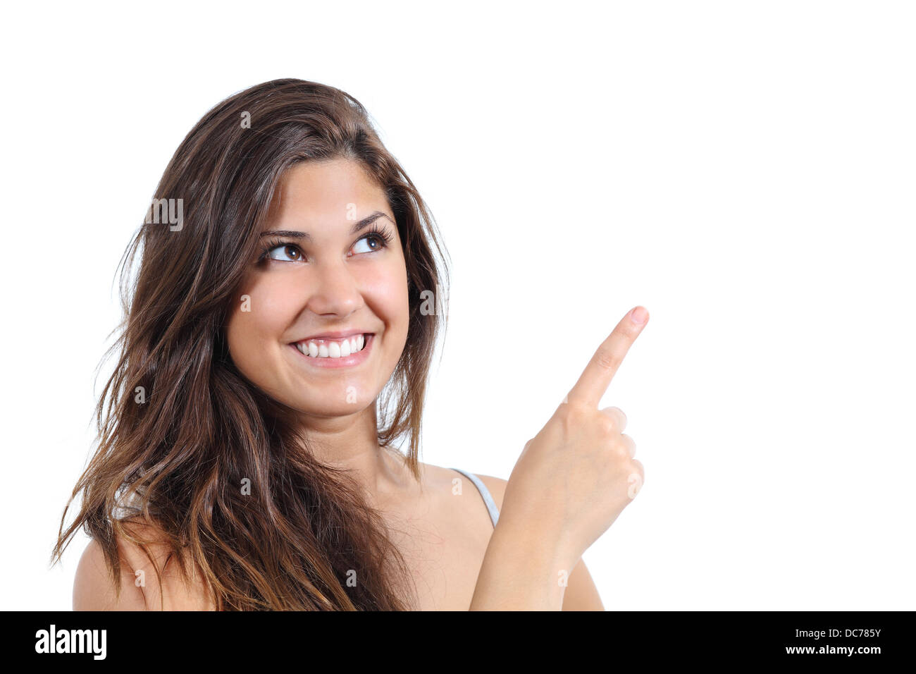 Close up of a beautiful woman pointing and looking above isolated on a ...
