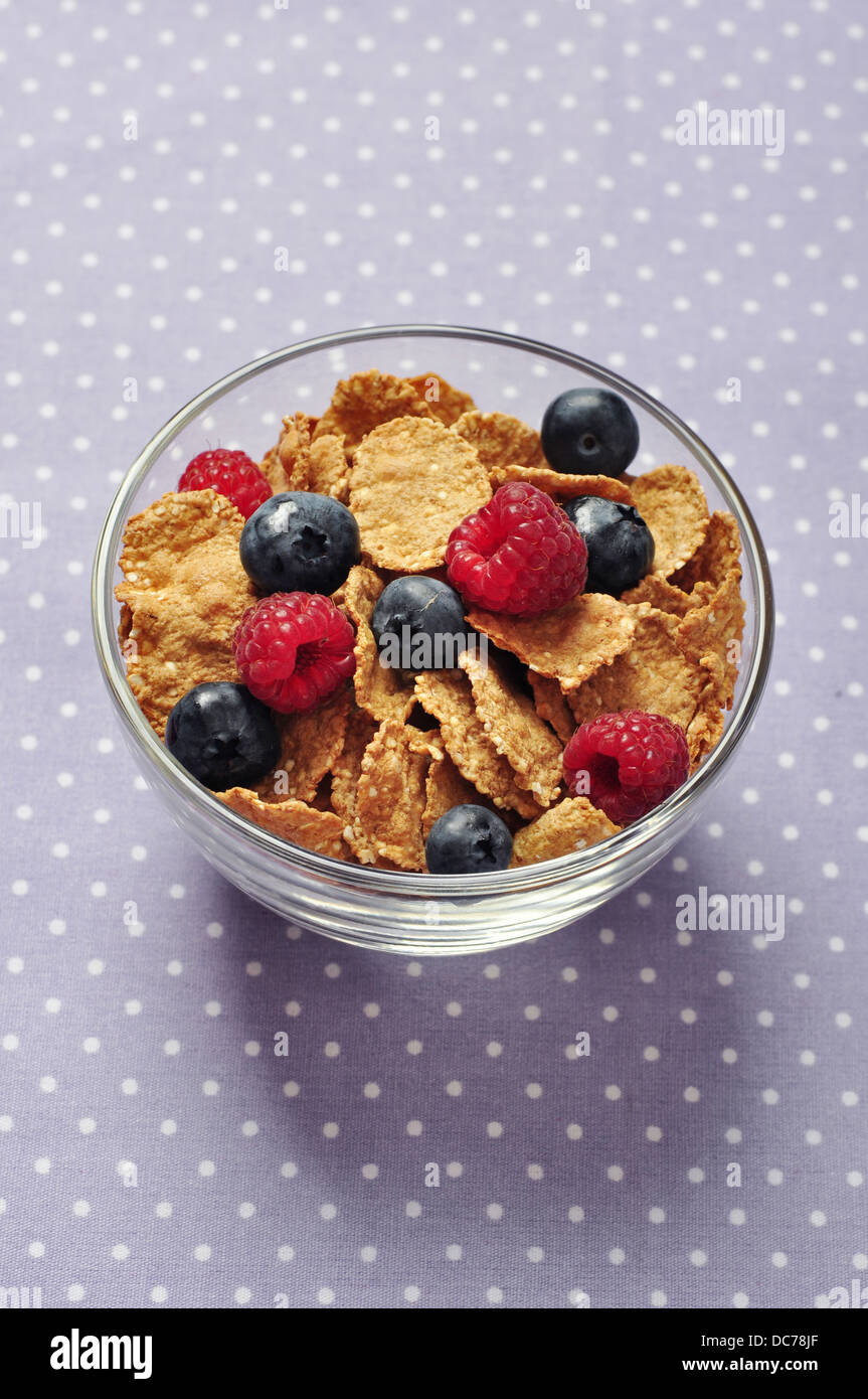 cereal flakes with raspberry and blueberry in glass bowl Stock Photo ...