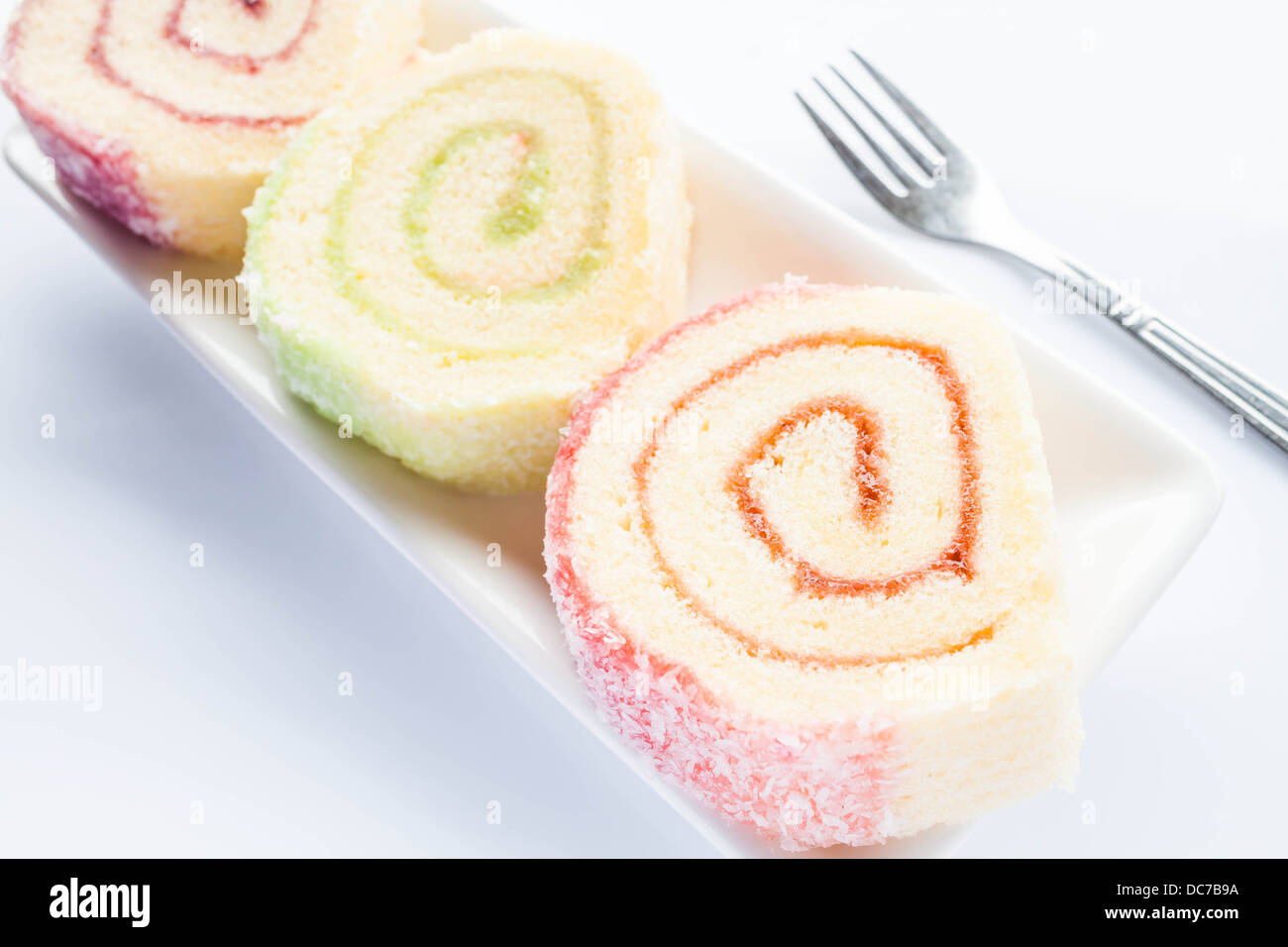 Set of colorful jam roll cakes with fork, stock photo Stock Photo - Alamy
