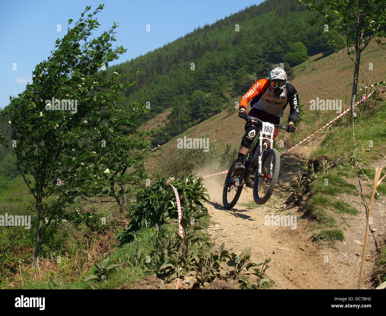 Mountain biker on dusty track Stock Photo - Alamy