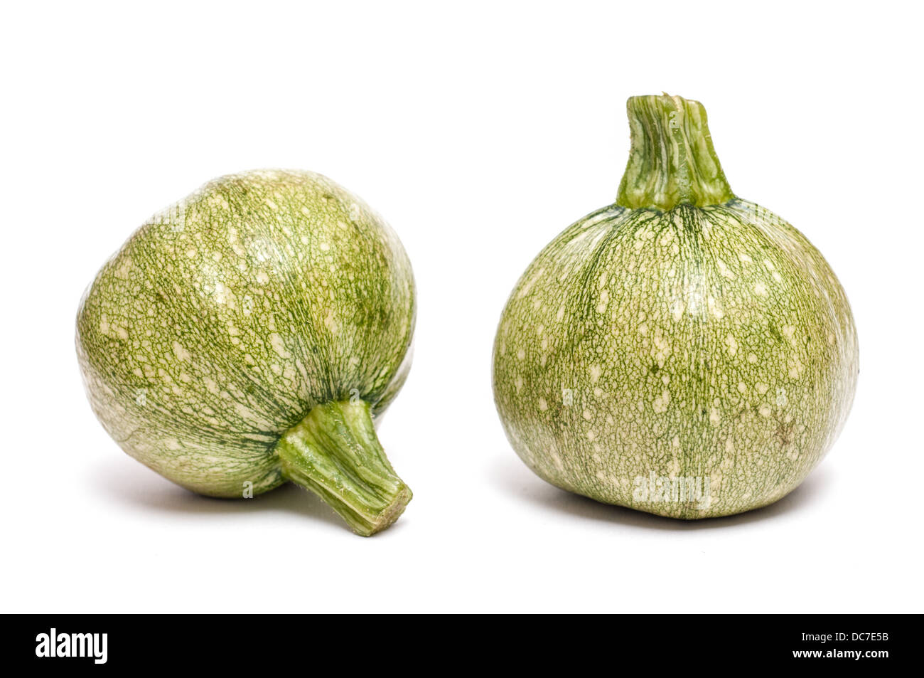 Two round green courgettes in front of a white background Stock Photo ...