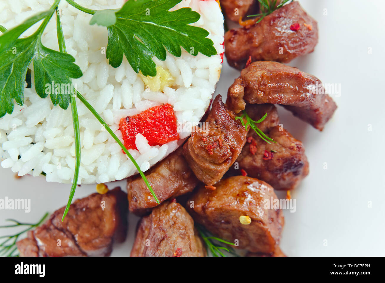 Shish kebab with rice on a white plate Stock Photo - Alamy