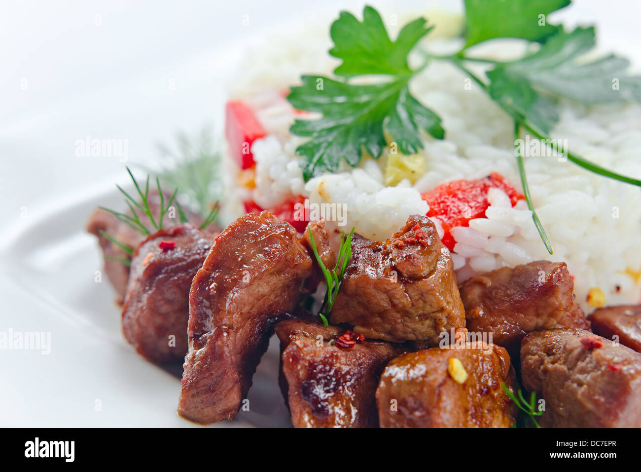 Stewed mutton with rice on a white plate Stock Photo - Alamy