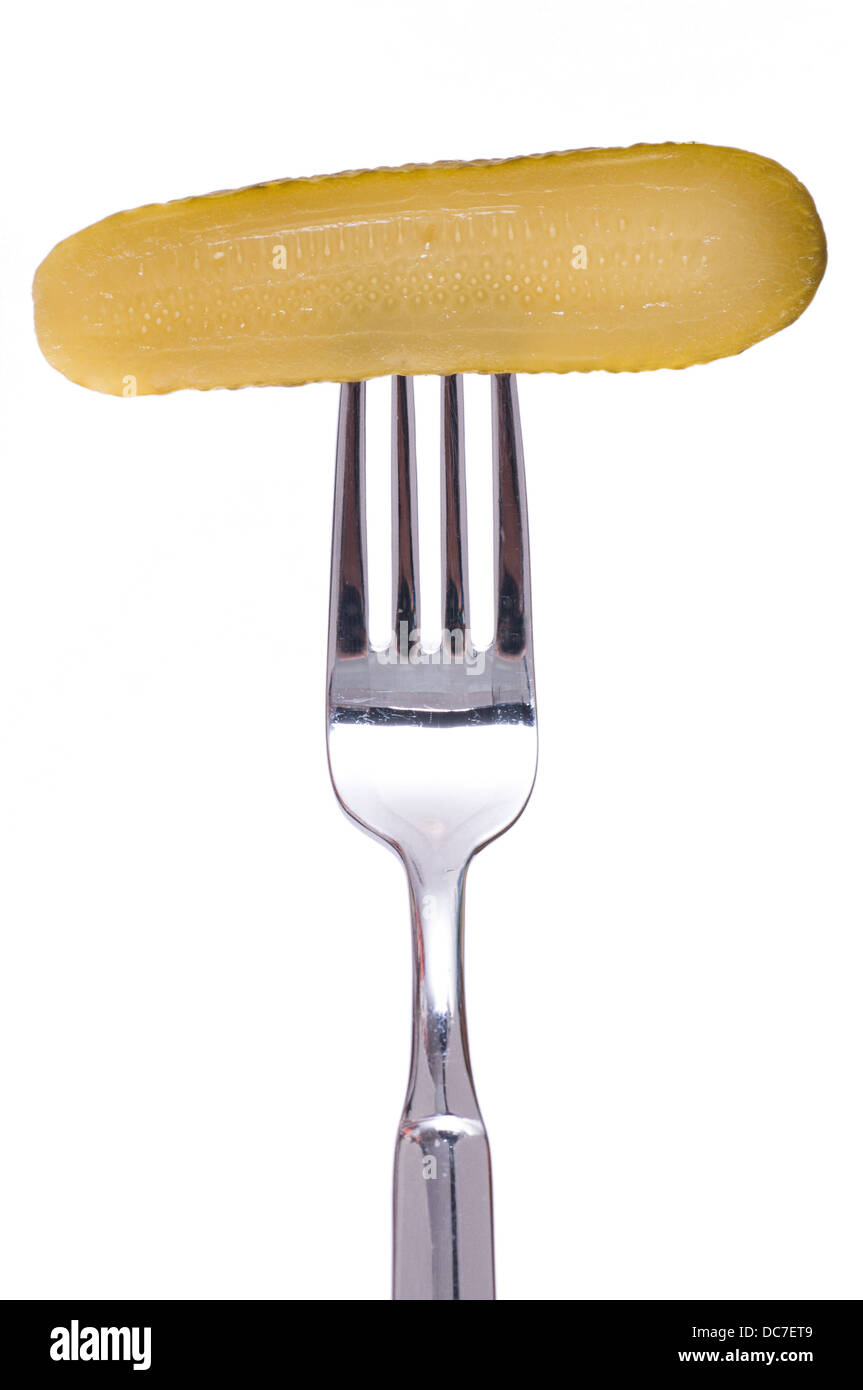 Dill pickle on a fork is white isolated Stock Photo - Alamy