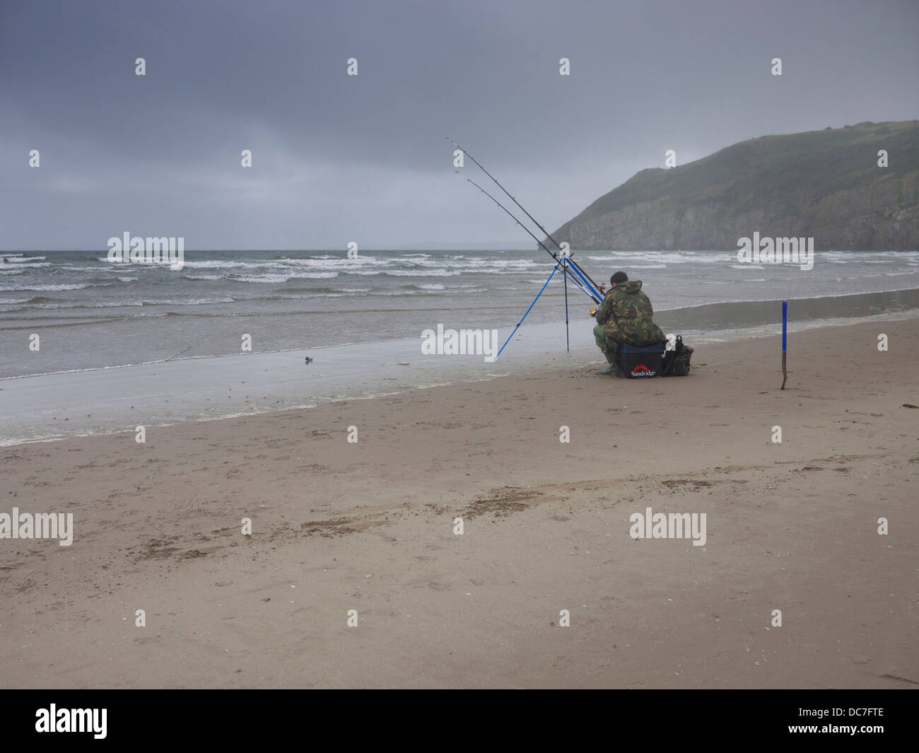 Fishing off the beach Stock Photo - Alamy