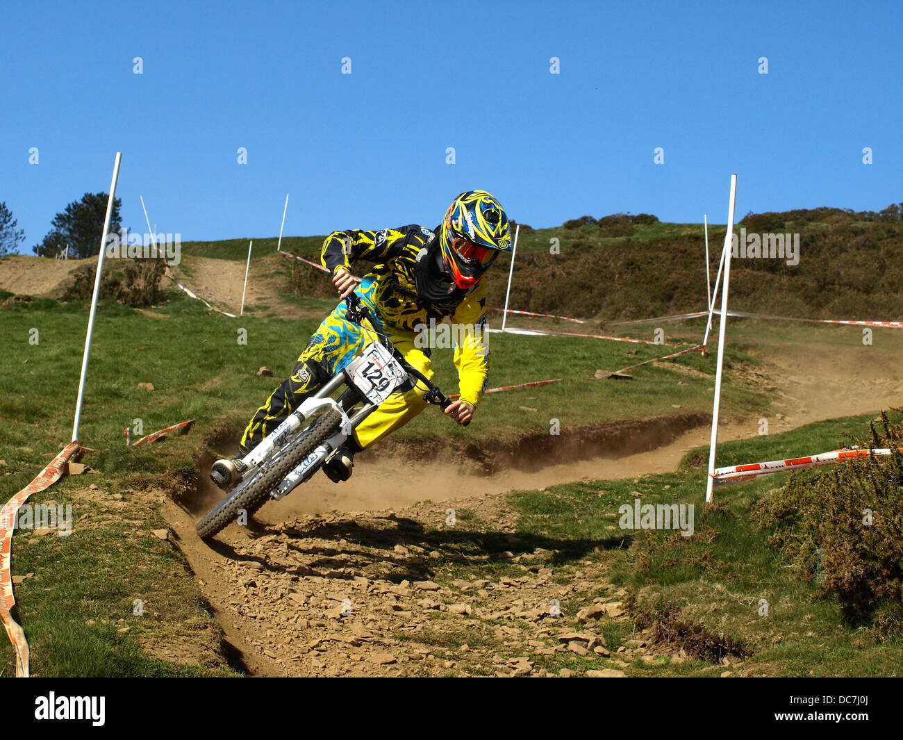 Mountain biker on dusty track Stock Photo - Alamy