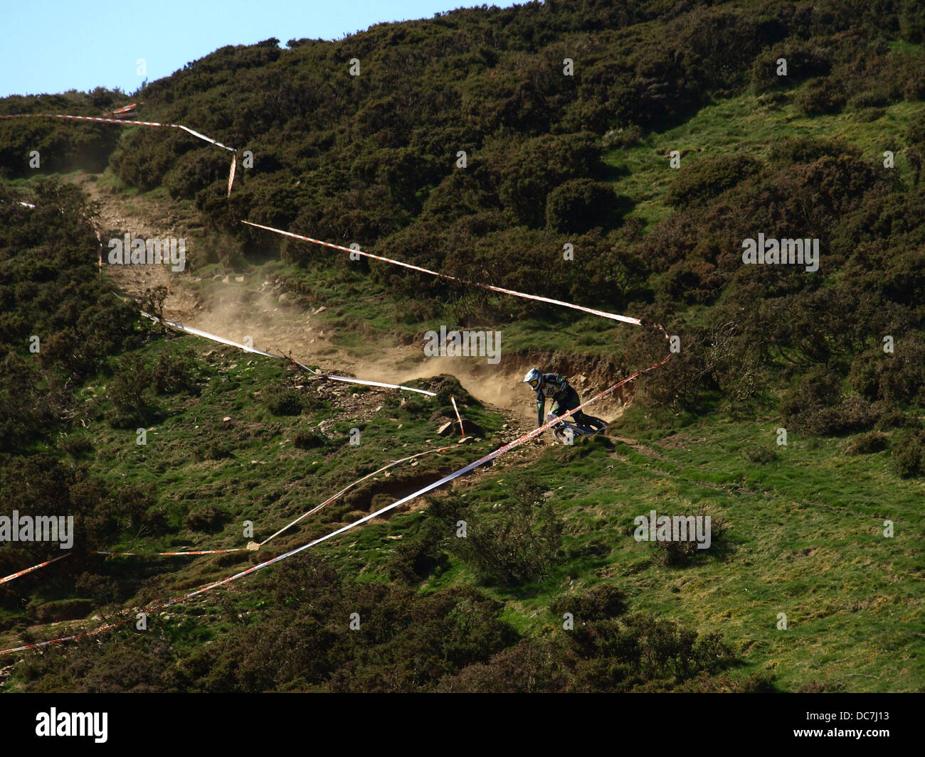 Mountain biker on dusty track Stock Photo - Alamy