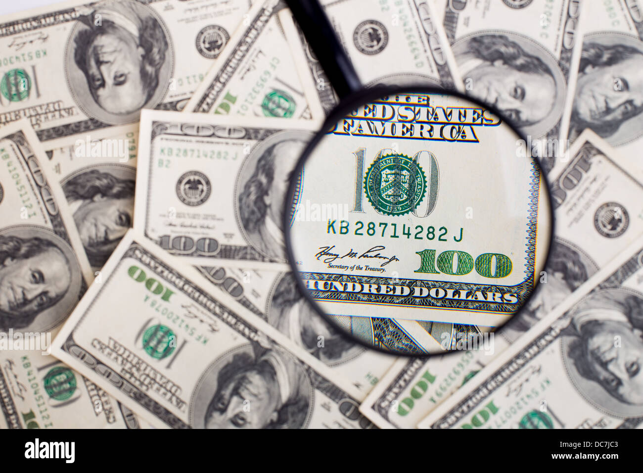 Dollars and black magnifying glass Stock Photo - Alamy