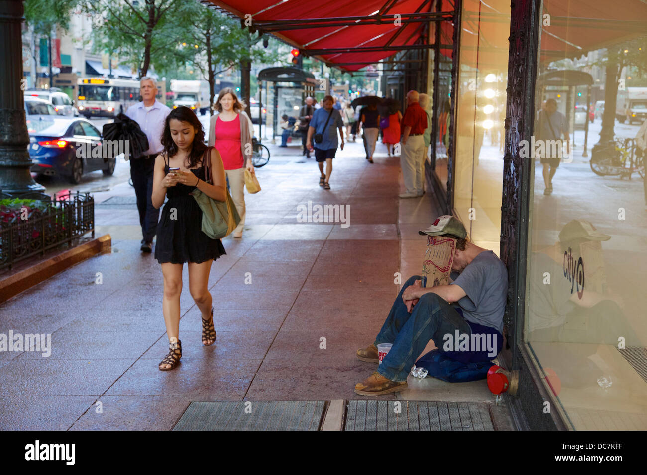 Homeless man, passerby texting. State Street, Chicago Illinois Stock ...