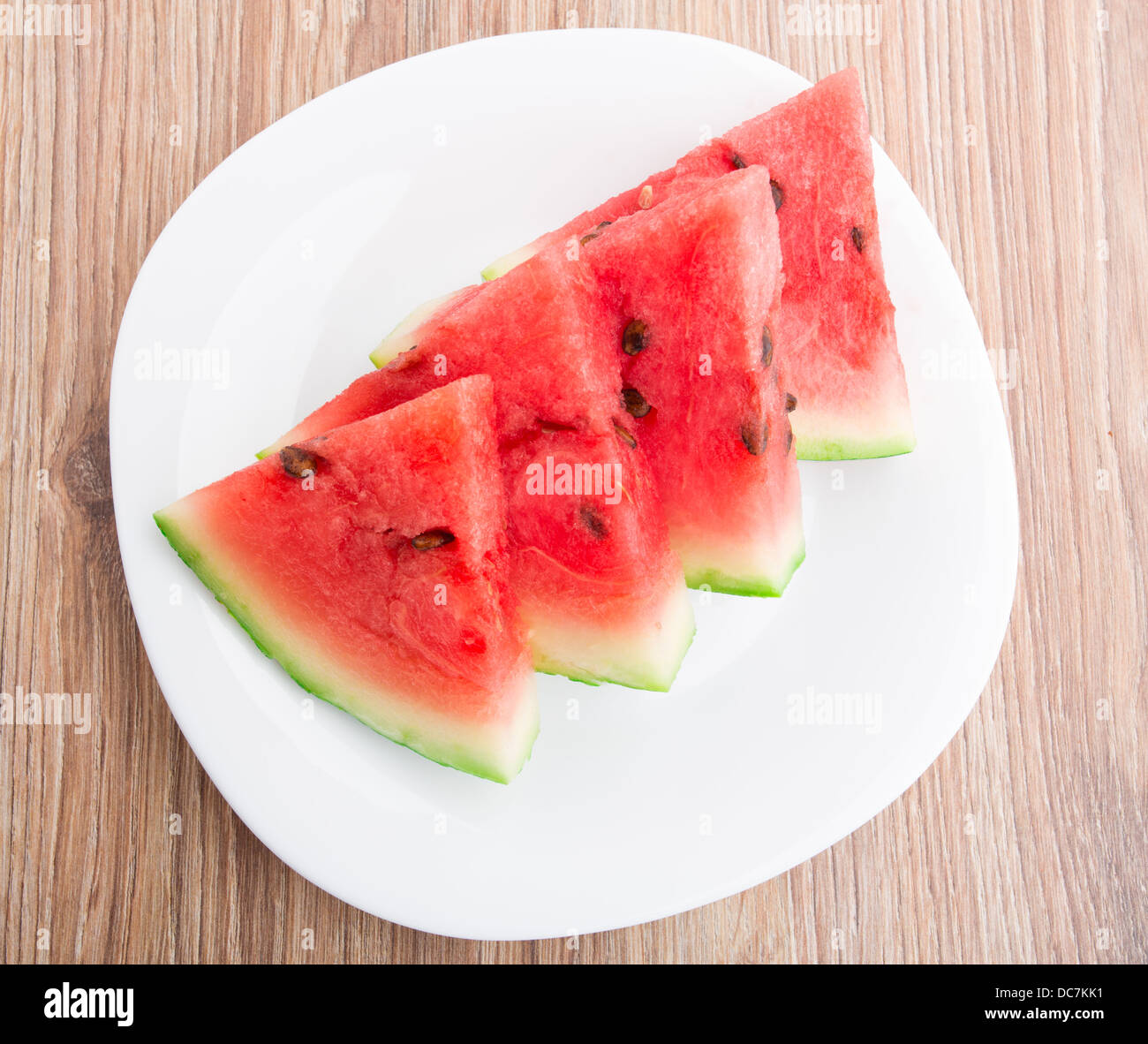 Watermelon slices on white plate Stock Photo - Alamy
