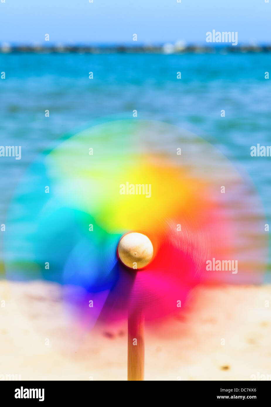 Colourful toy windmill spinning in the wind creating a brillliant blur ...