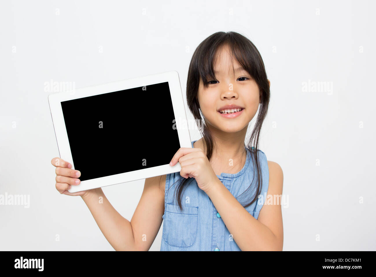 Happy Asian child with tablet computer Stock Photo - Alamy